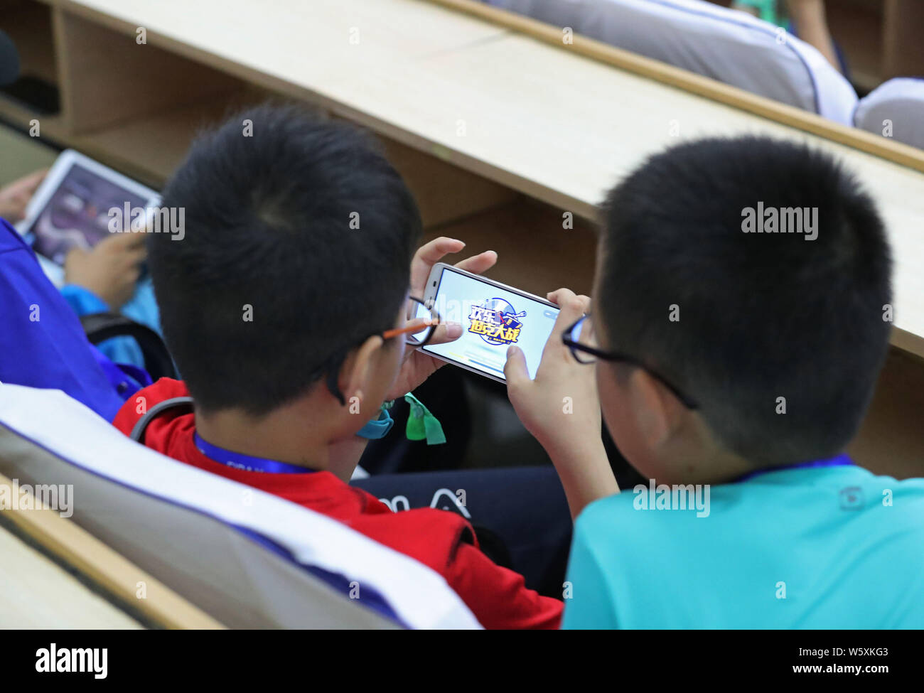 --FILE--Students play video games on smartphones at a competition ...