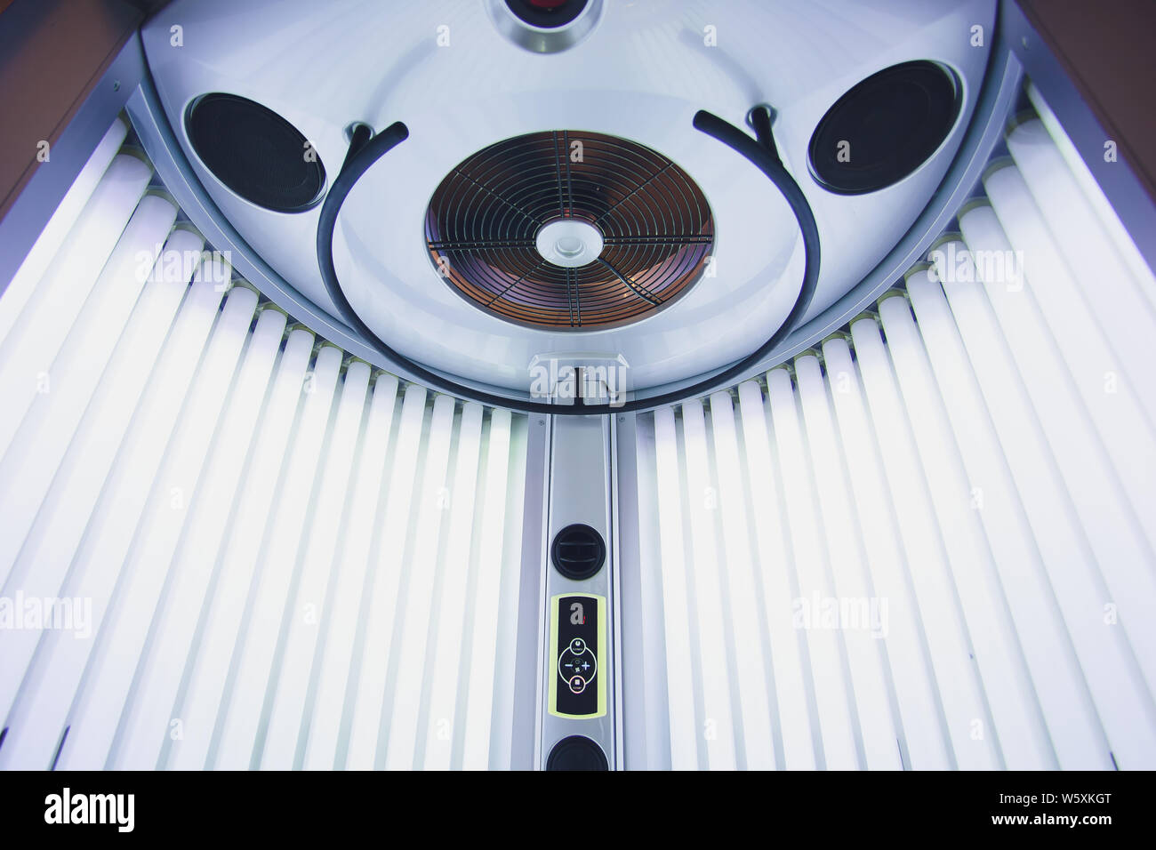 Vertical Tanning turbo Solarium Light Machine with glowing blue light ...