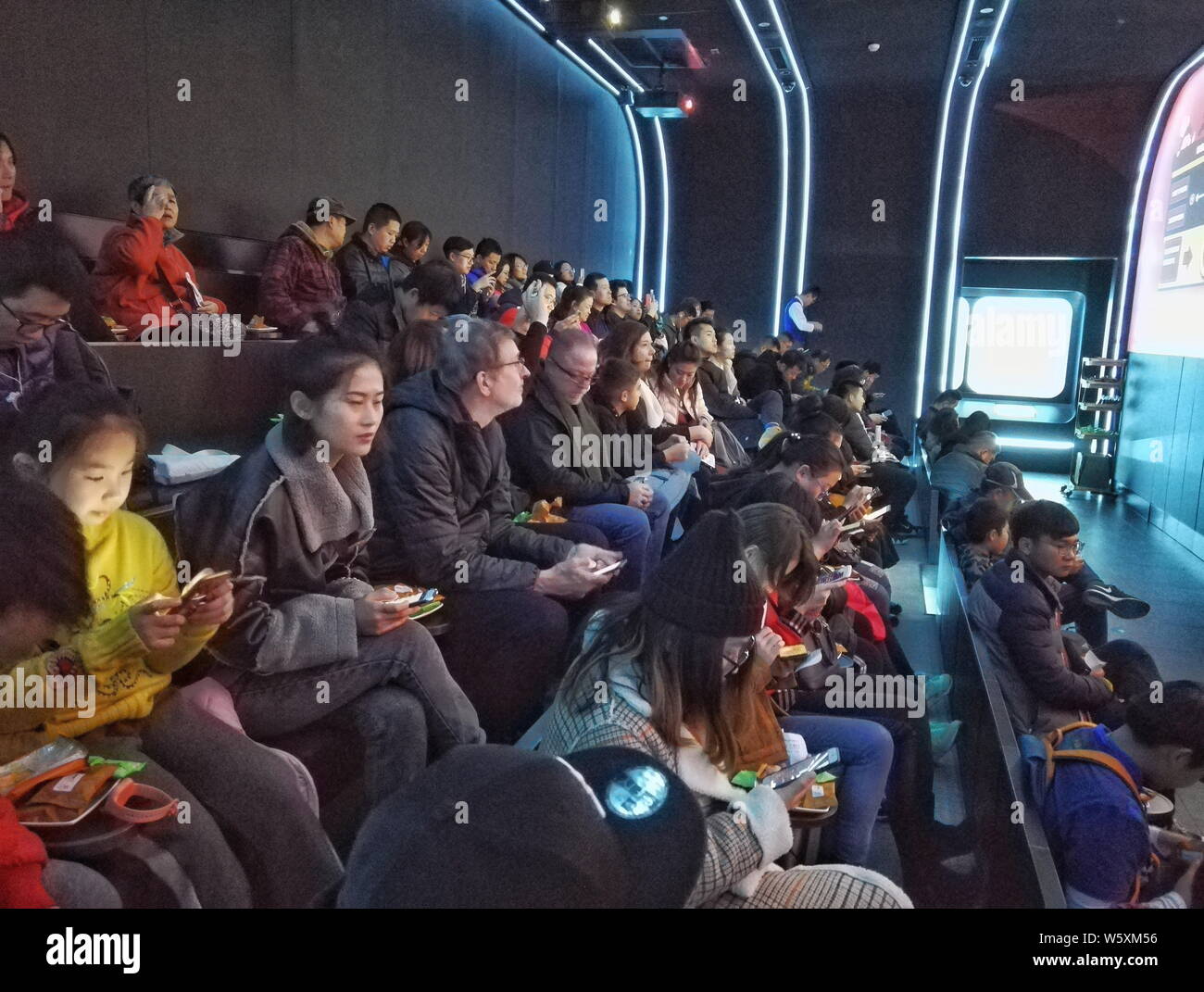 Customers watch movies as they wait for tables at the first AI-operated ...