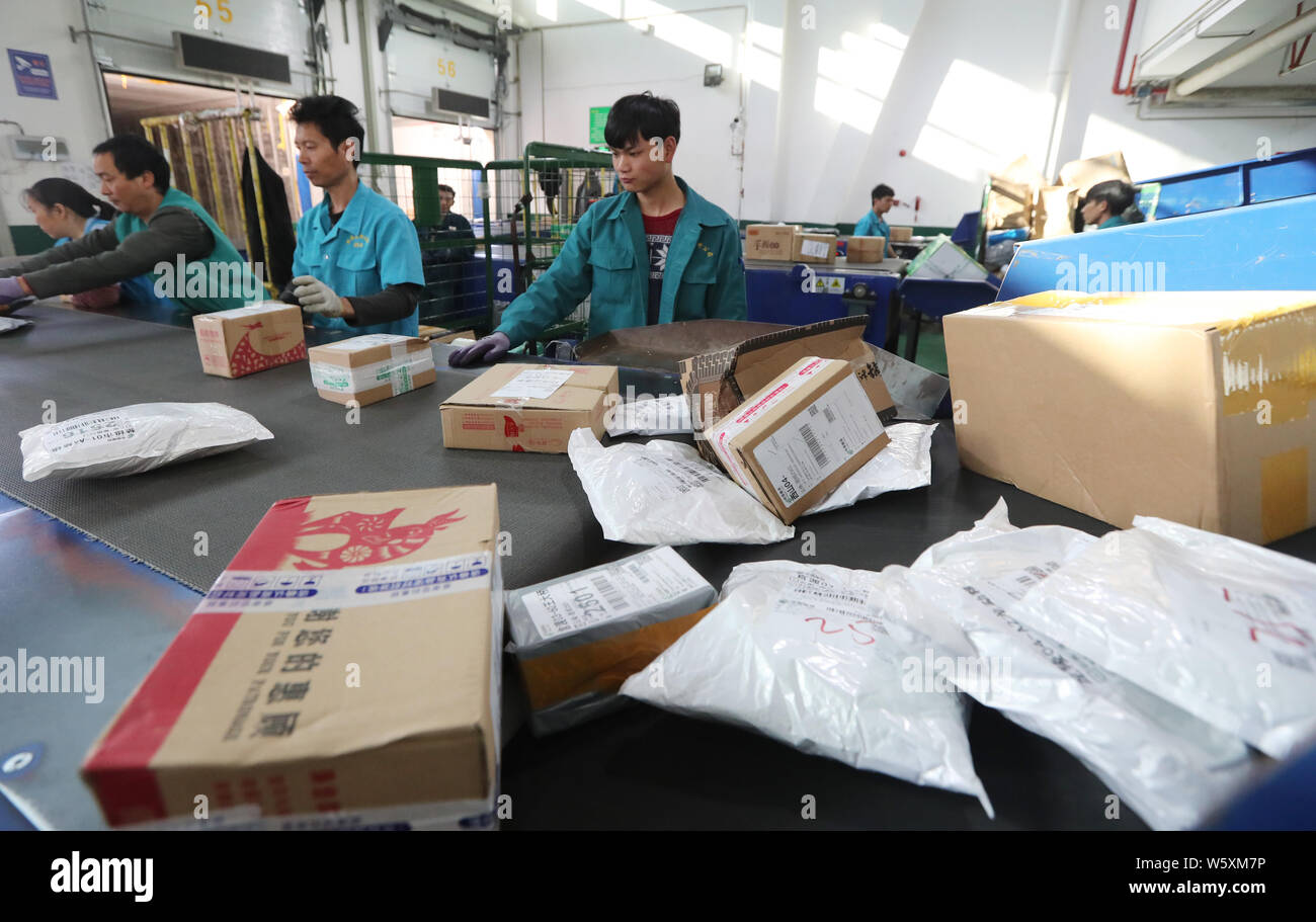 Chinese workers sort out parcels, most of which are from Singles' Day online shopping, at a ...