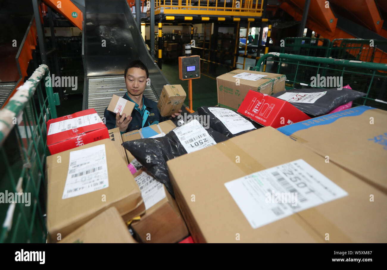 Chinese workers sort out parcels, most of which are from Singles' Day online shopping, at a ...