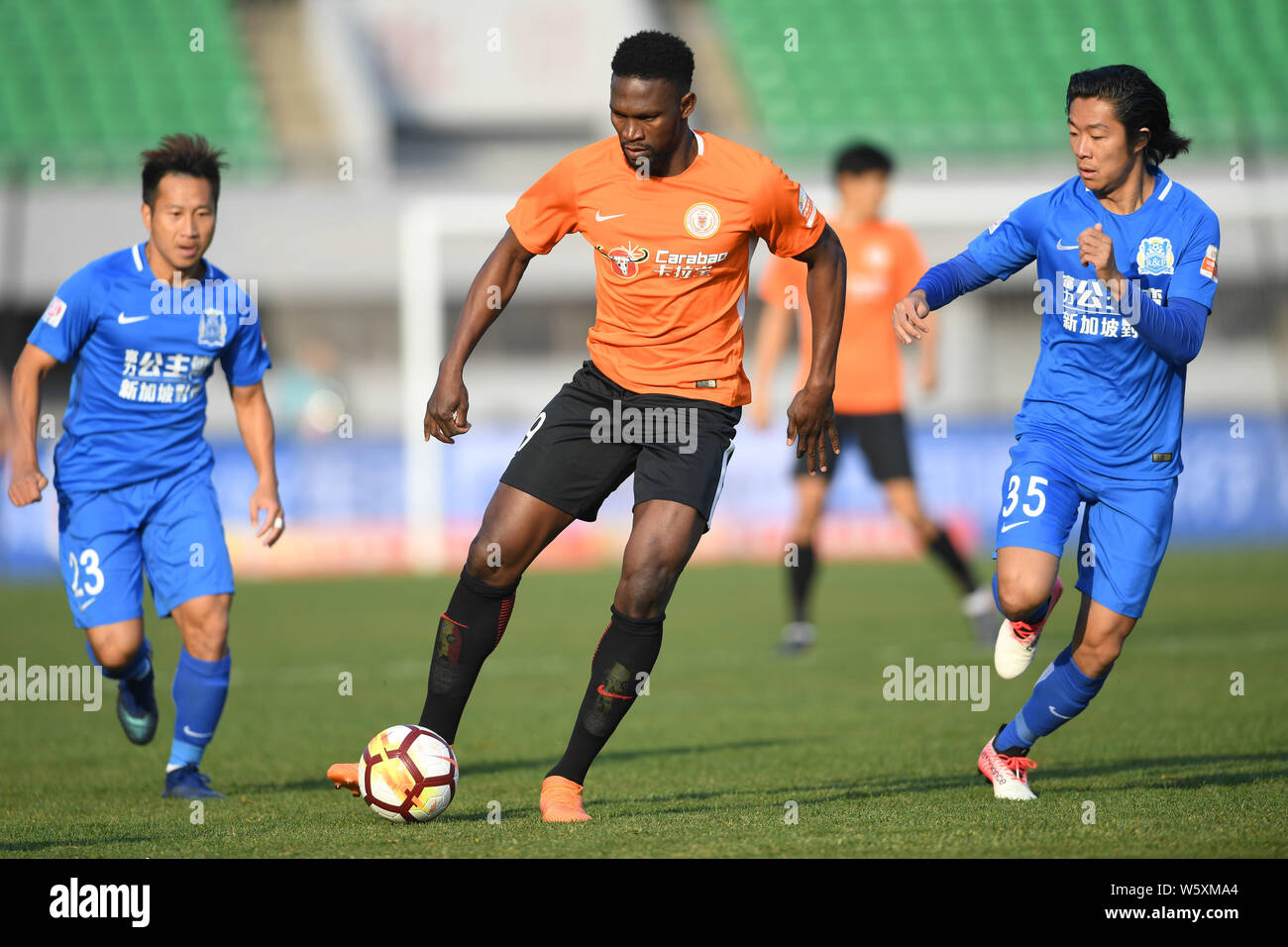 Senegalese football player Makhete Diop of Beijing Renhe, center ...