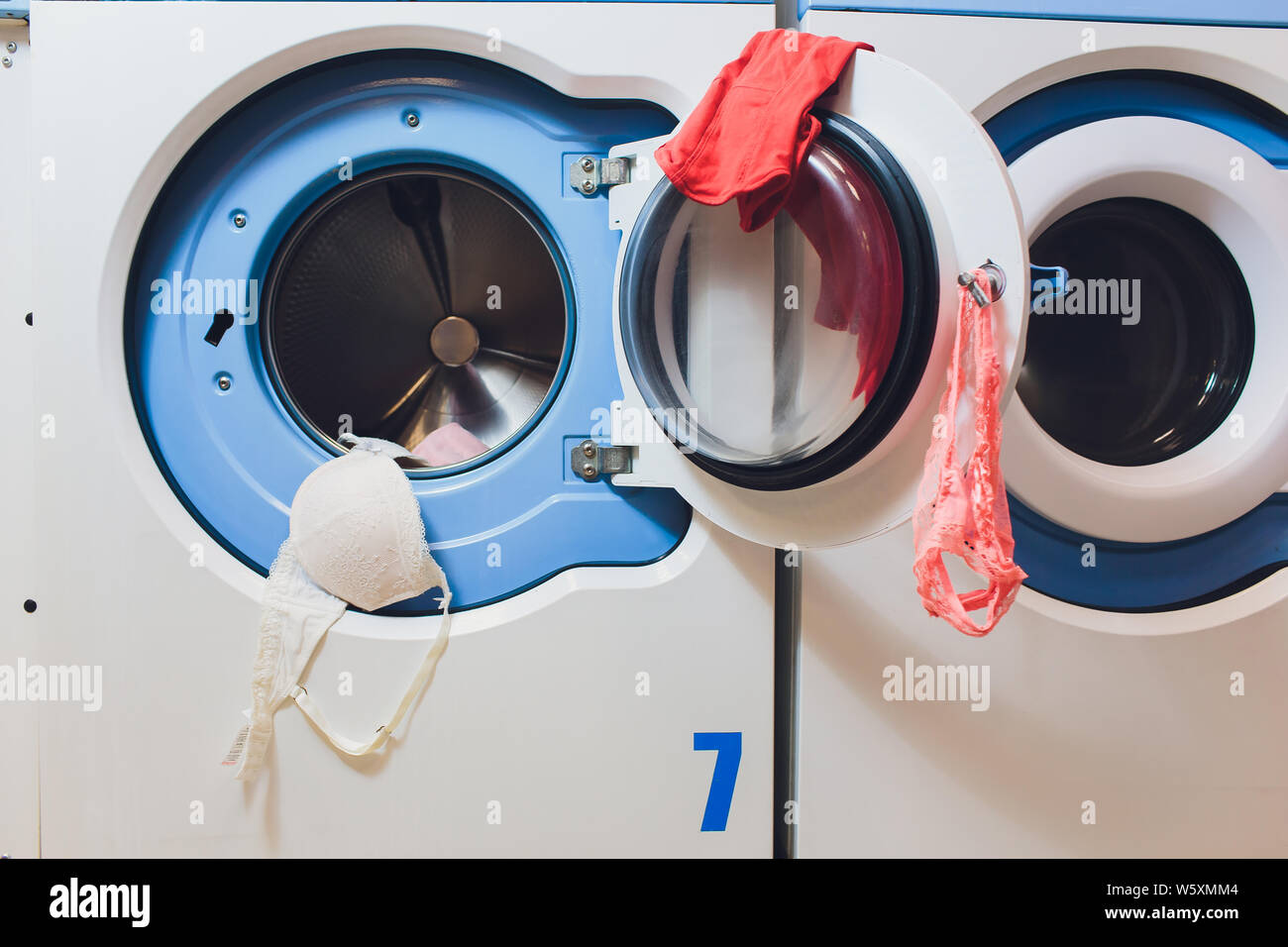 woman taking color clothes from washing machine Stock Photo - Alamy