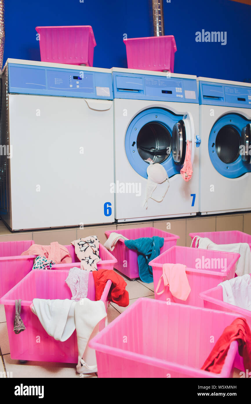 woman taking color clothes from washing machine Stock Photo - Alamy