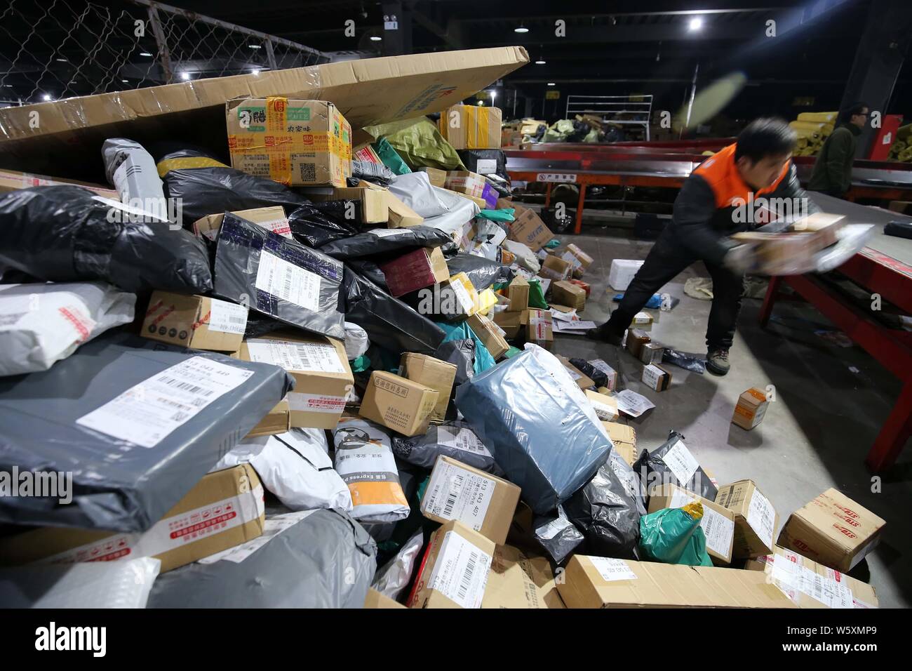 Chinese workers sort out parcels, most of which are from Singles' Day online shopping, at a ...