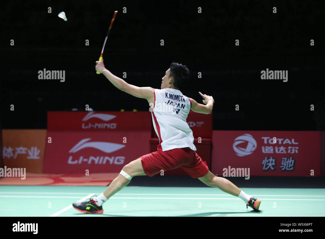 Kento Momota of Japan plays a shot to Chou Tien Chen of Chinese Taipei ...