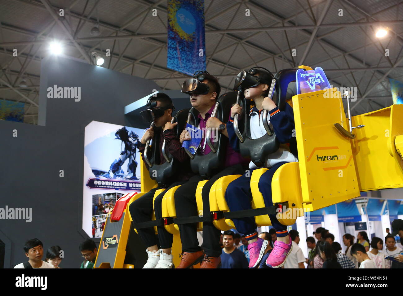 --FILE--People experience virtual reality (VR) devices during the 2018 ...