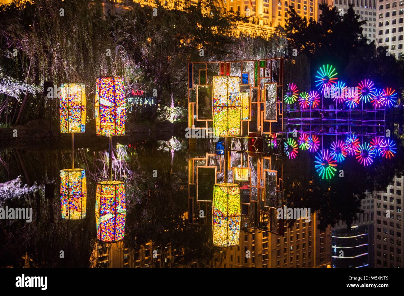Tourists and visitors view colored lights during the seventh Guangzhou International Light ...