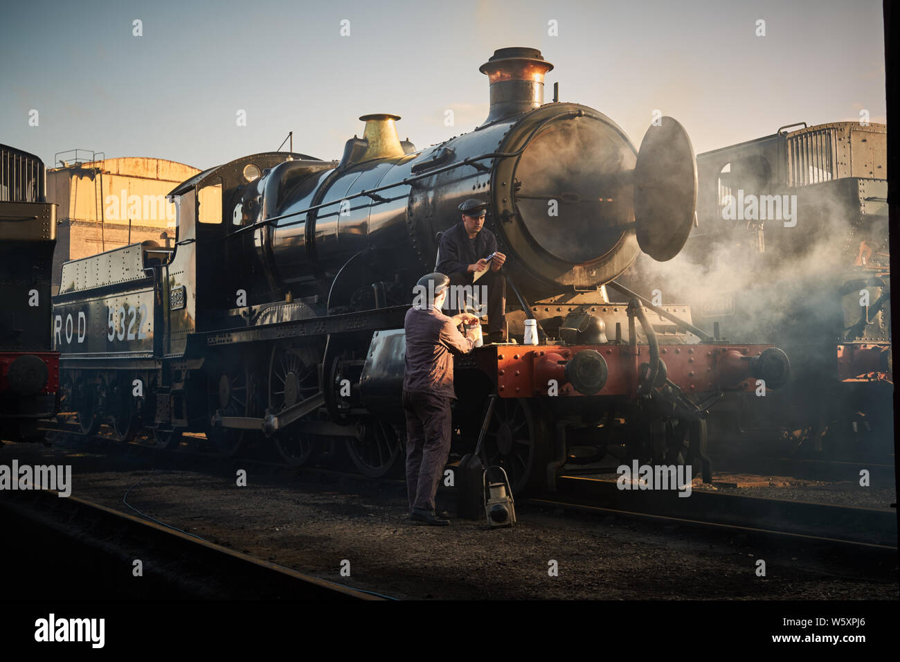 Re-enactors pose in front of a locomotive creating a nostalgic scene ...