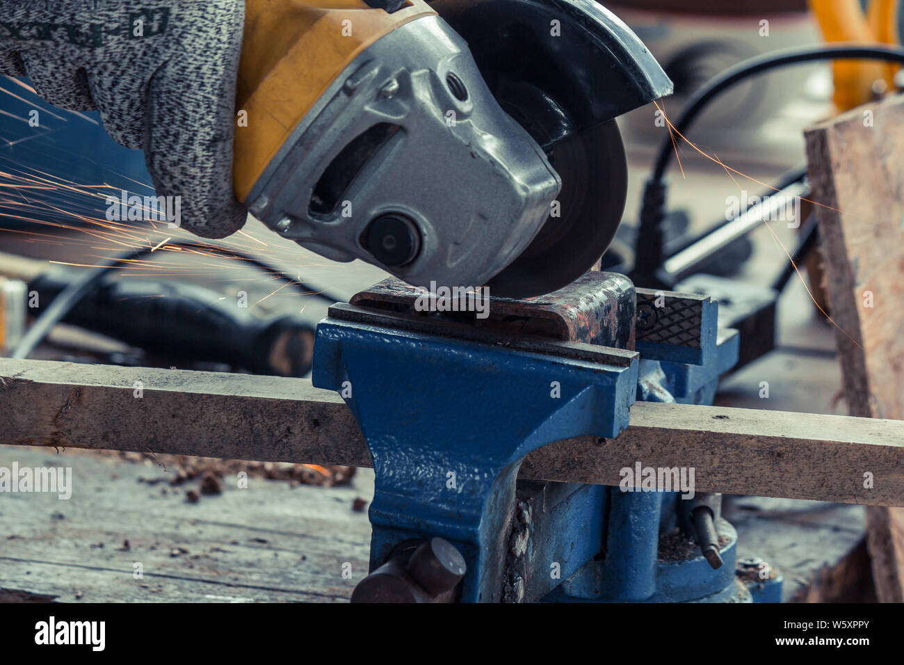 Sparks flying over the working during metal grinding Stock Photo - Alamy