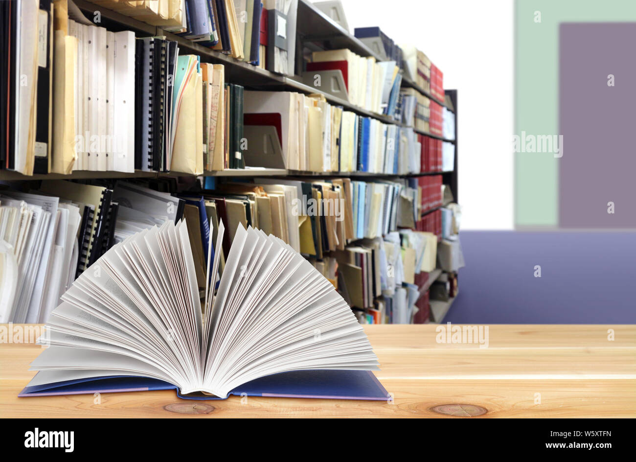 open book on the wooden table in library Stock Photo - Alamy