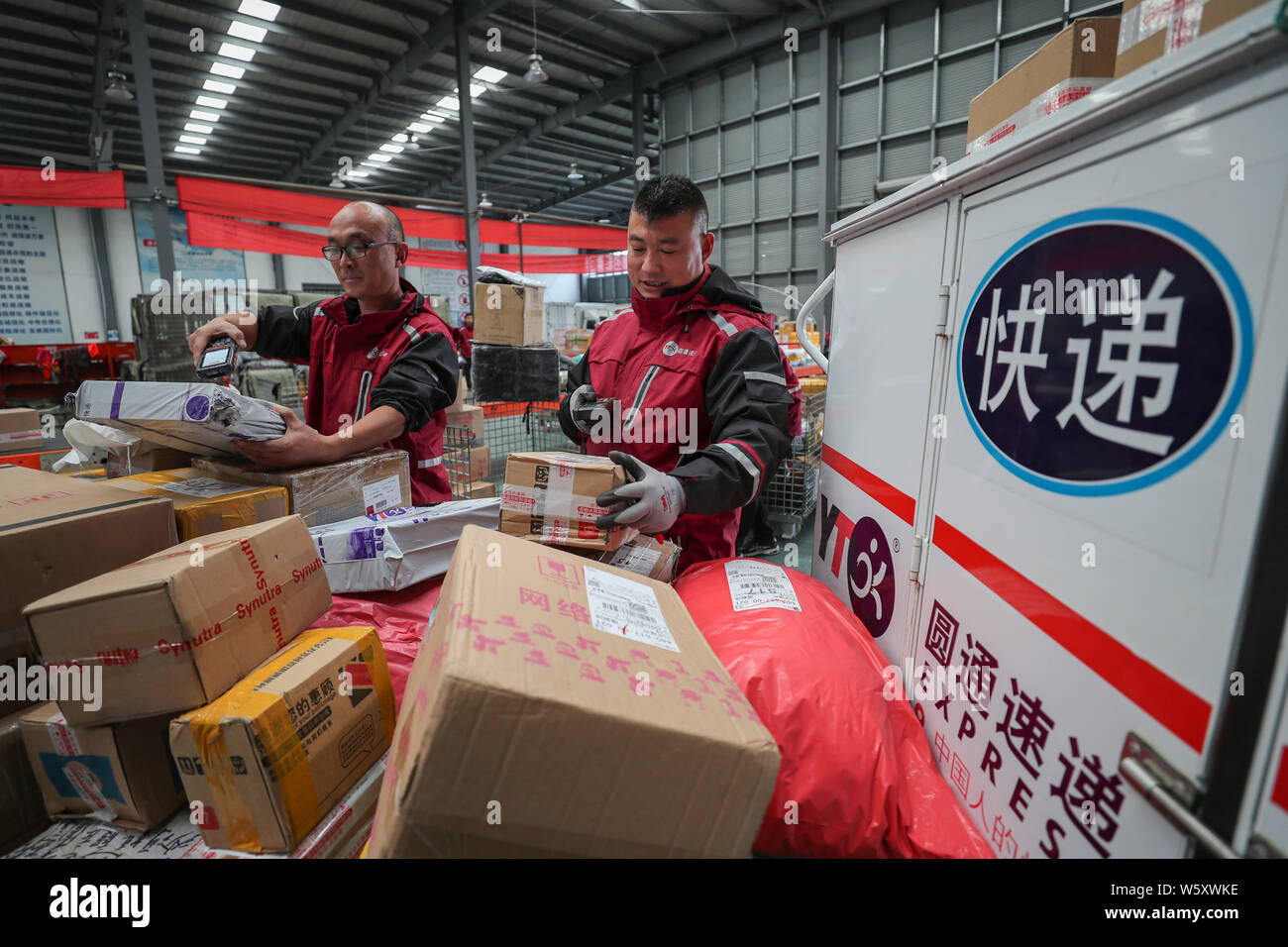 Chinese workers sort out parcels, most of which are from Singles' Day ...