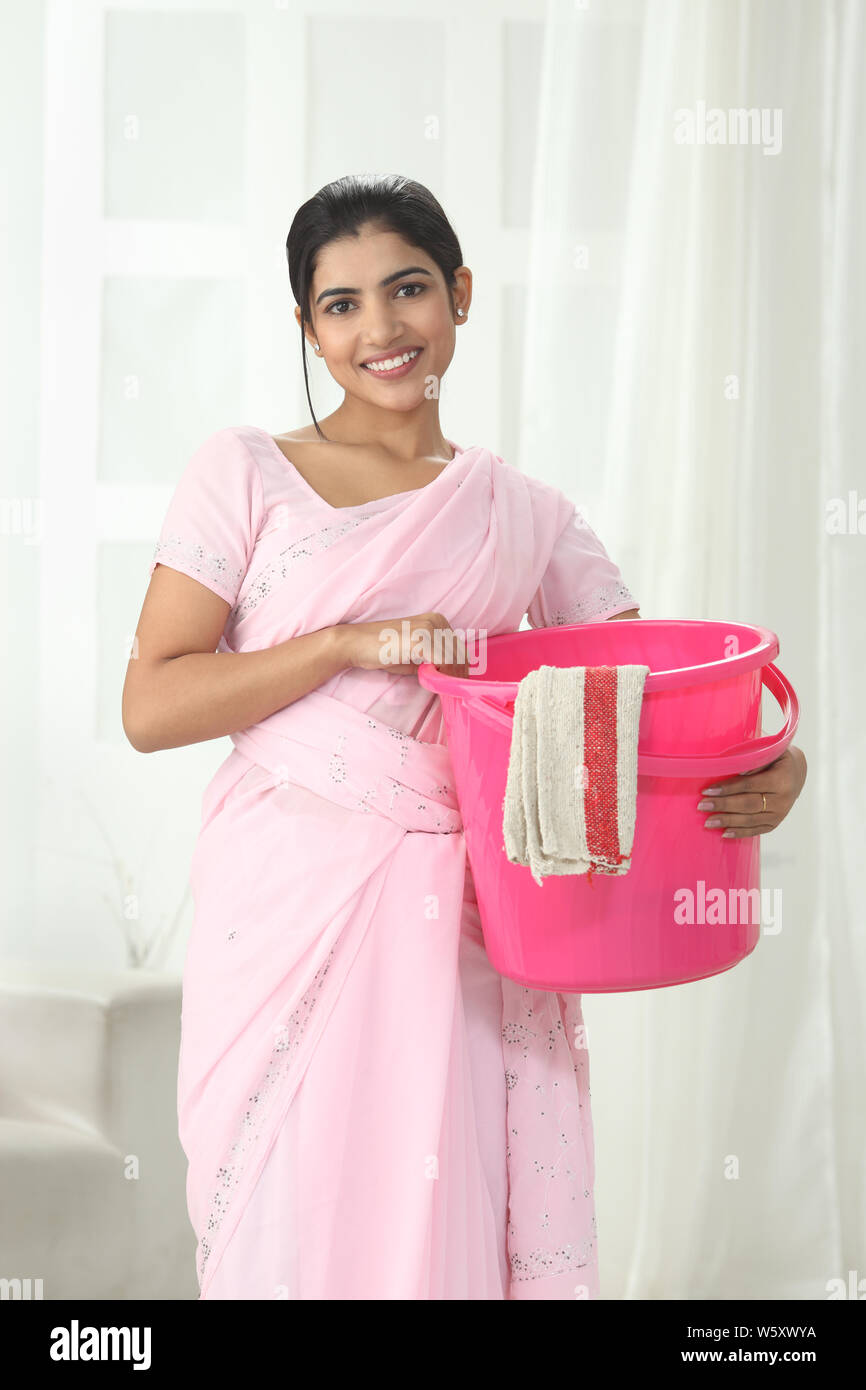 Smiling housewife holding bucket hi-res stock photography and images ...