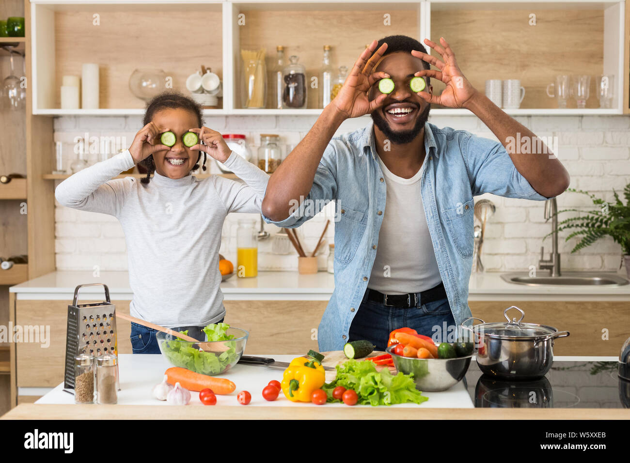 Funny father and daughter having fun while cooking Stock Photo - Alamy