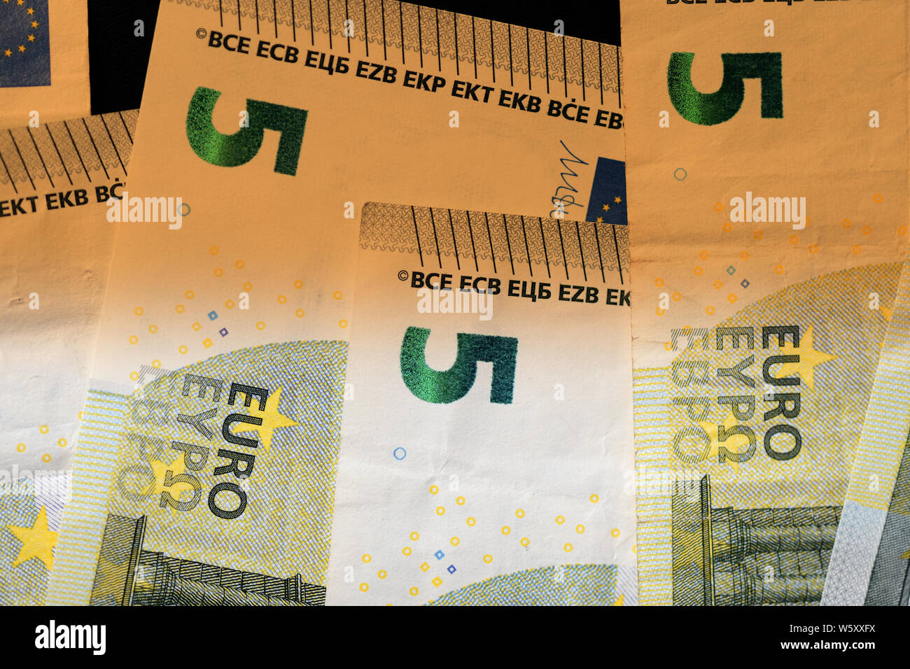 Five euro banknotes on a dark background close up. Money background ...