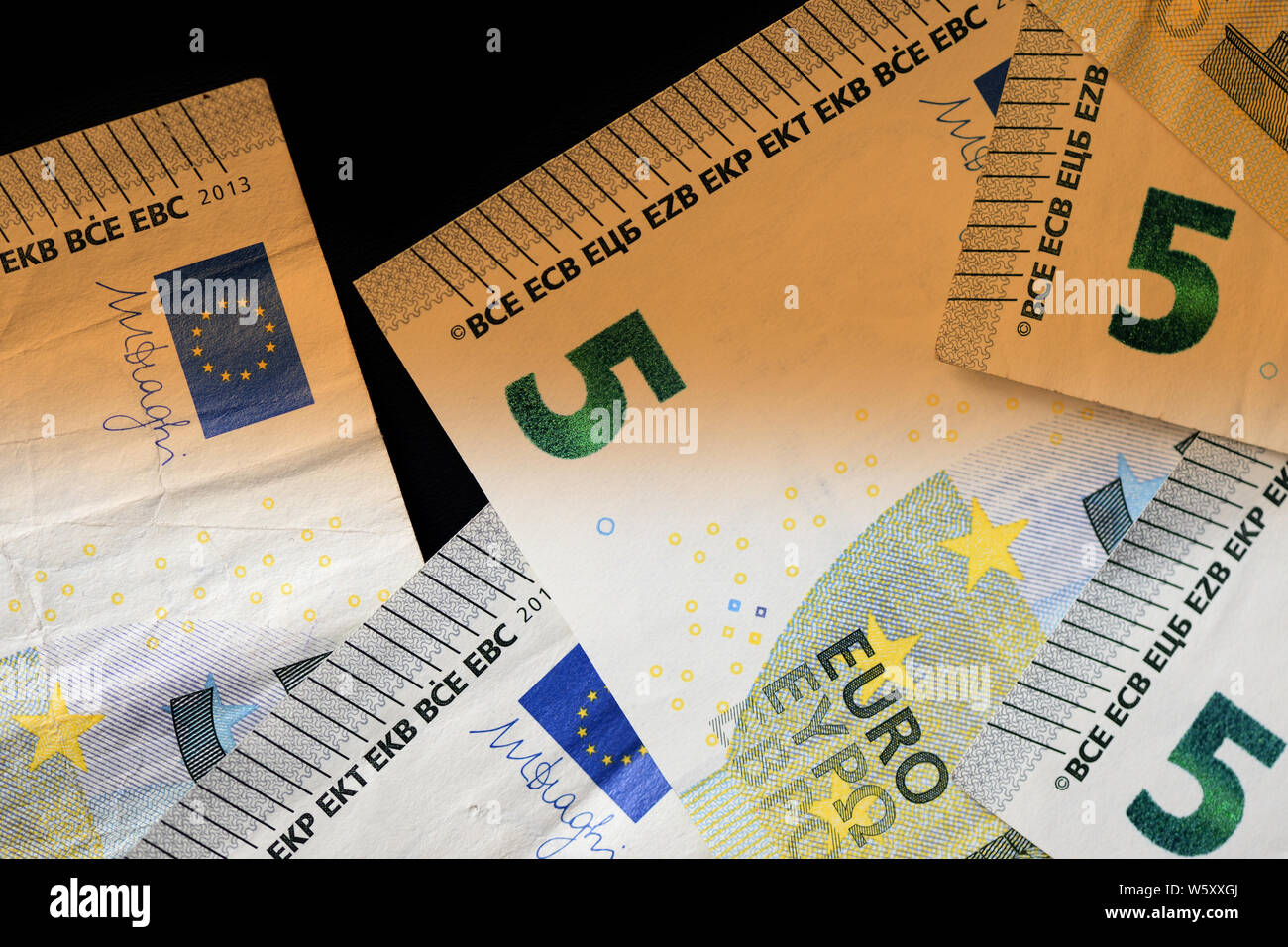 Five euro banknotes on a dark background close up. Money background ...