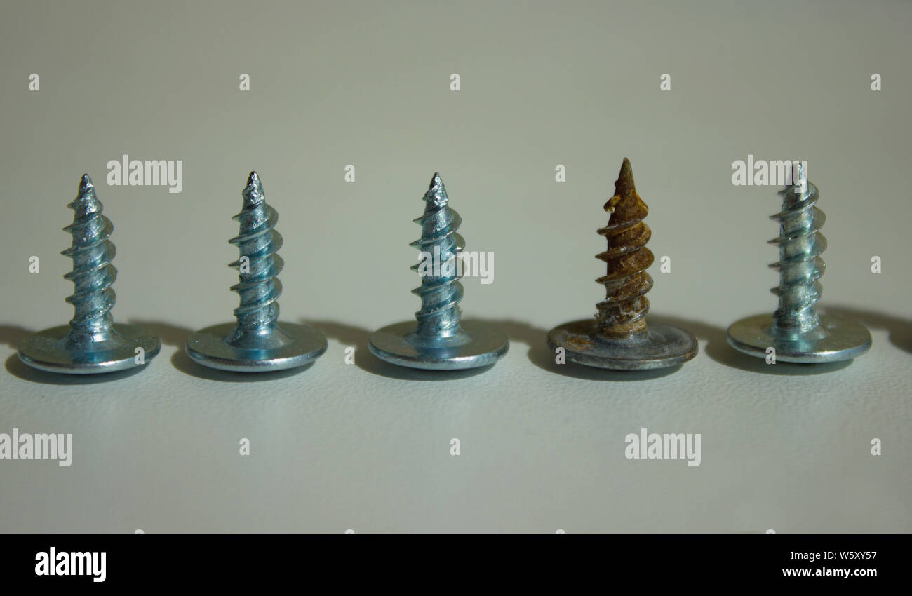 One old rusty screw in a row of new small screws Stock Photo - Alamy
