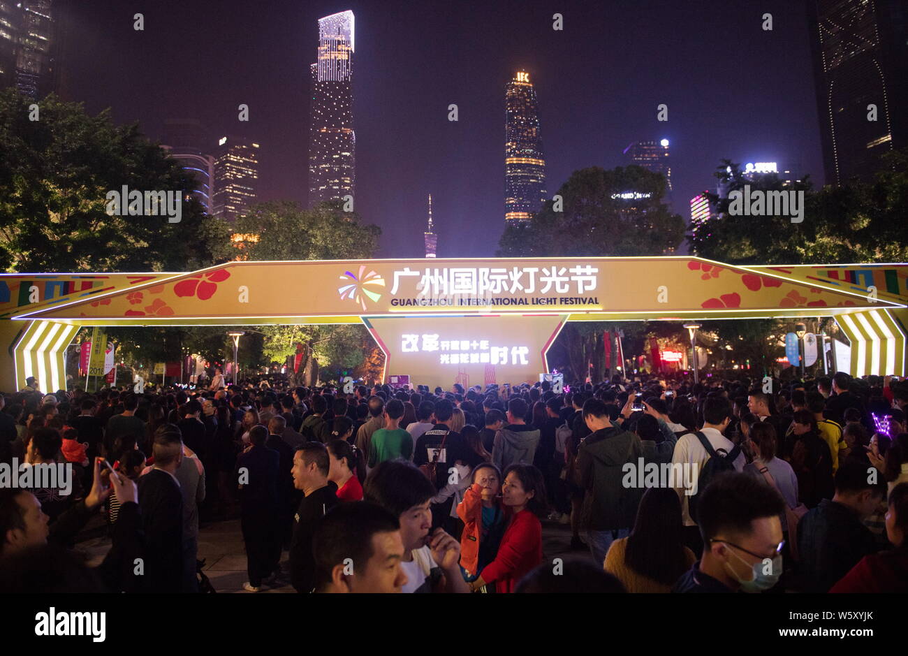 Tourists and visitors view colored lights during the seventh Guangzhou ...