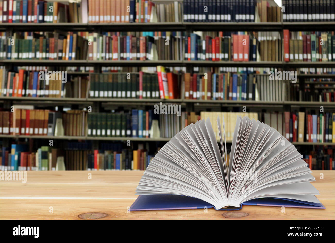 open book on the wooden table isolated on white Stock Photo - Alamy