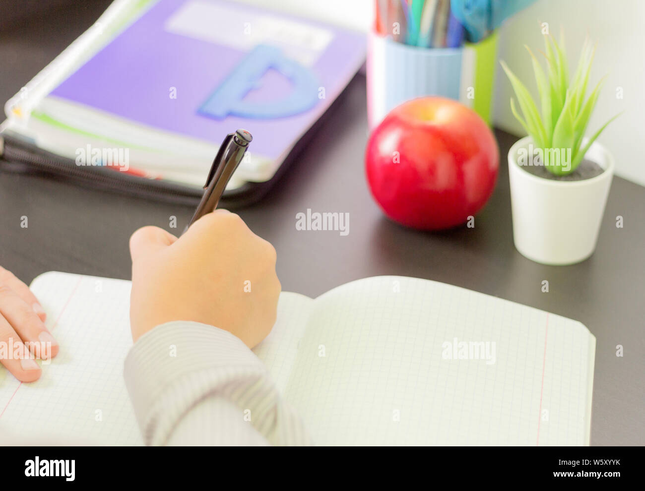 Student playing with pen classroom hi-res stock photography and images ...