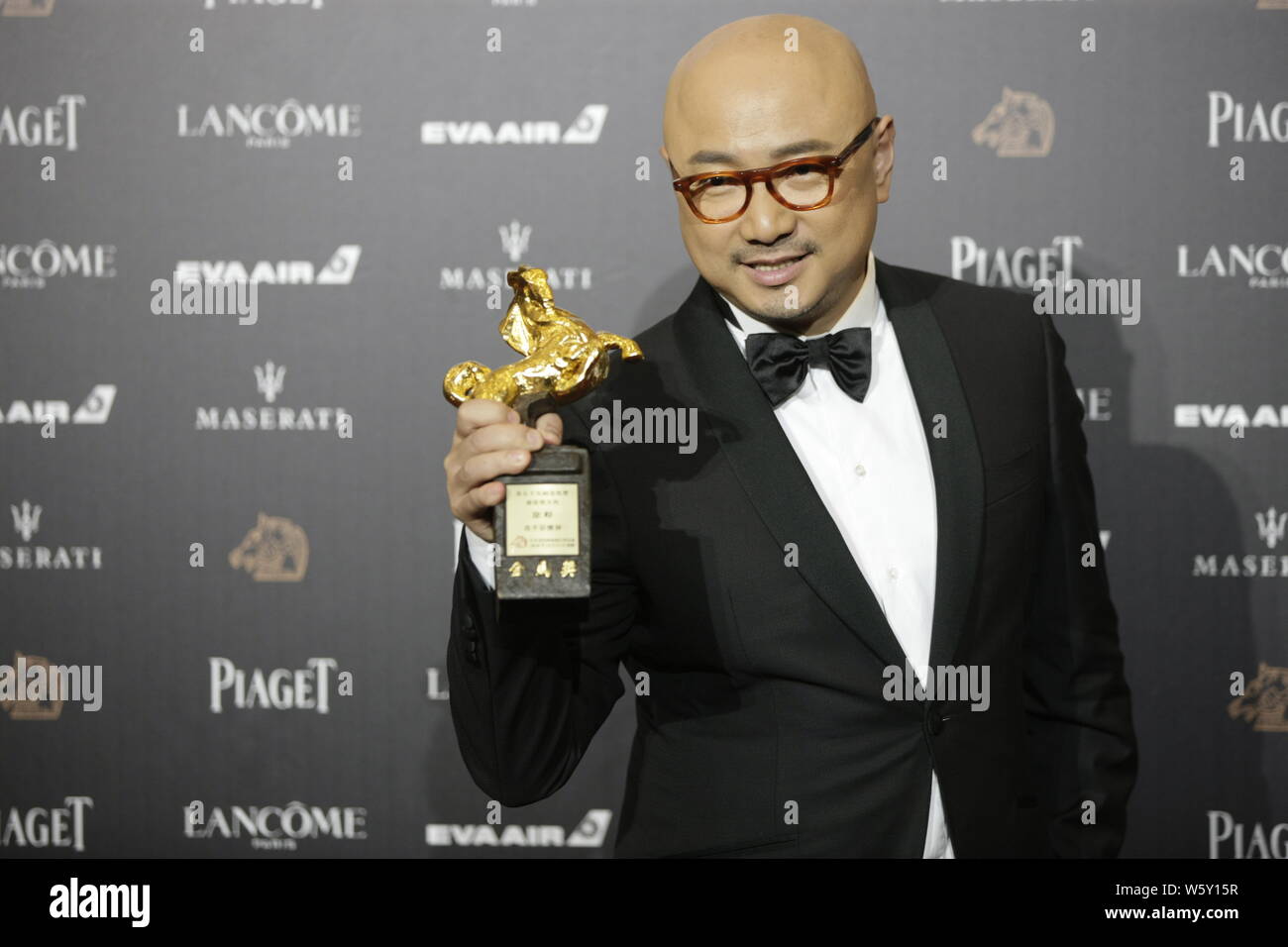 Chinese actor Xu Zheng poses with his trophy of the Best Leading Actor ...