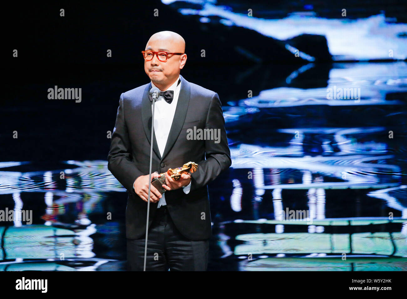 Chinese actor Xu Zheng speaks after being awarded with the trophy of ...