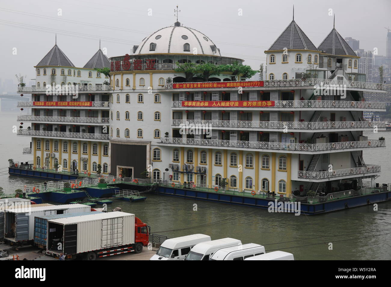 A massive floating restaurant is docked at a port on the Yangtze River ...
