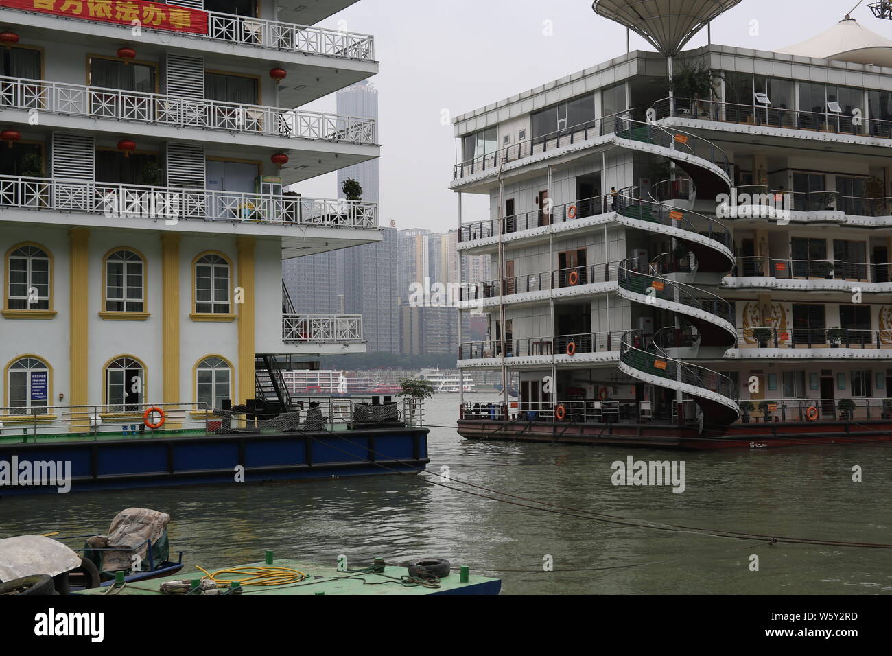 A massive floating restaurant is docked at a port on the Yangtze River ...