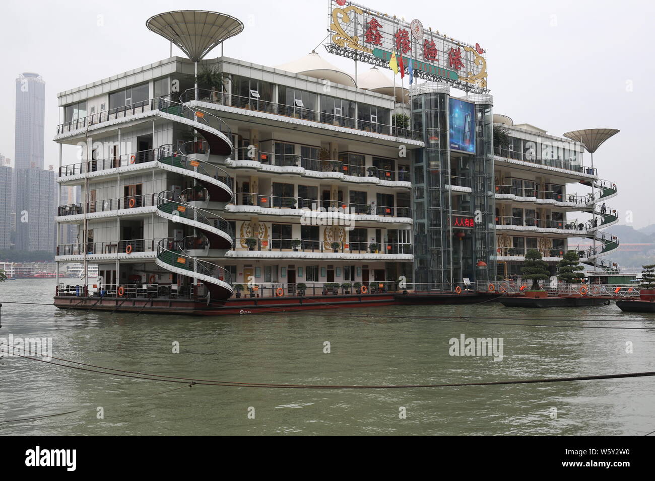 A massive floating restaurant is docked at a port on the Yangtze River ...