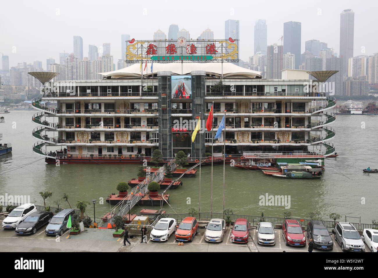 A massive floating restaurant is docked at a port on the Yangtze River ...