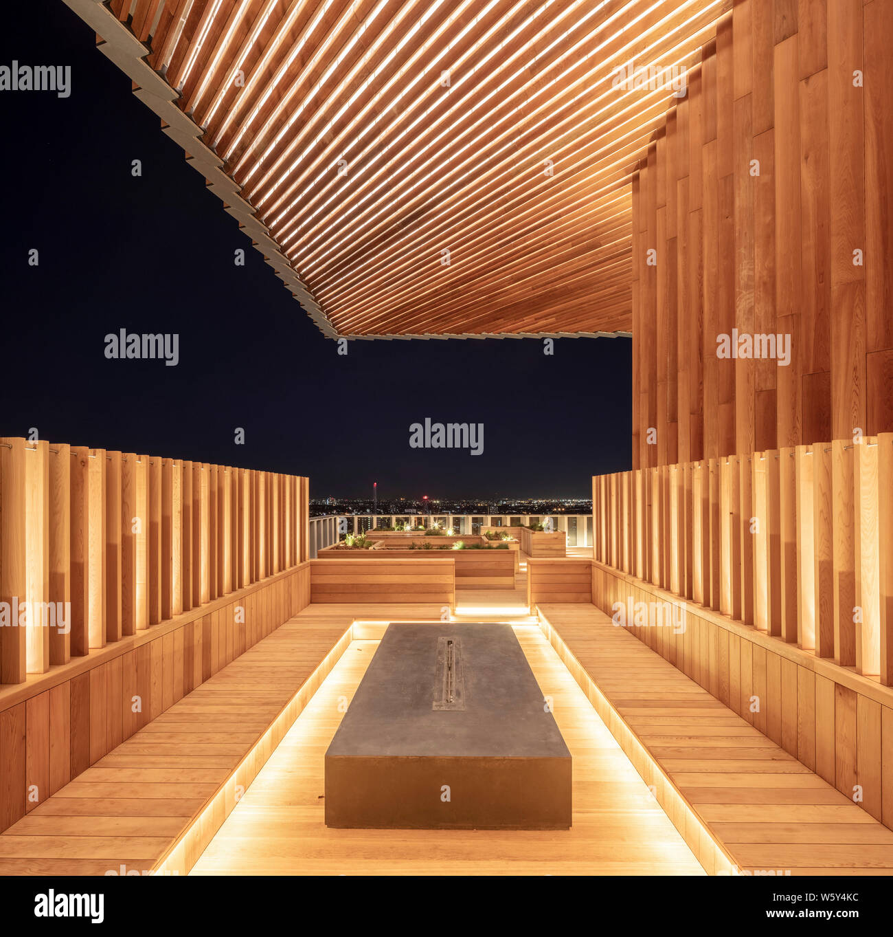 Timber decking and planting in sky garden, night view. The Stratford ...