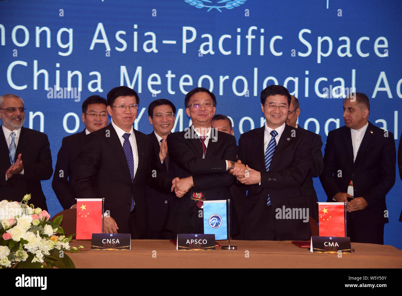 Li Xinjun, center, secretary-general of APSCO, speaks at the APSCO ...