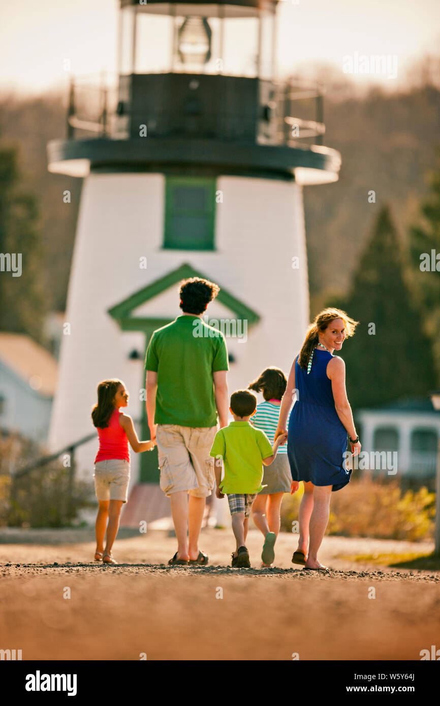 Family walking toward lighthouse together Stock Photo - Alamy