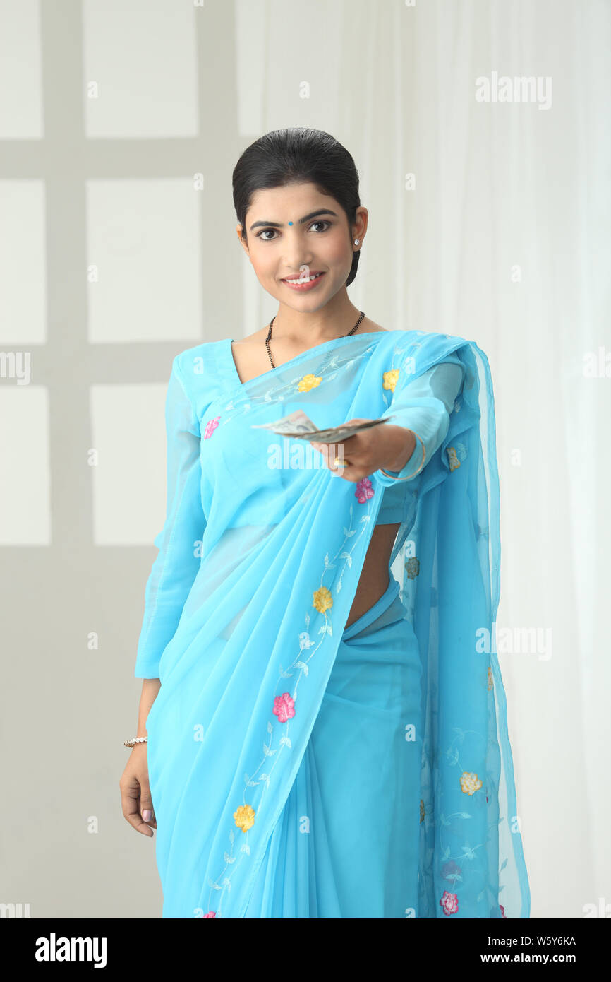 Woman holding one hundred rupee banknotes Stock Photo - Alamy