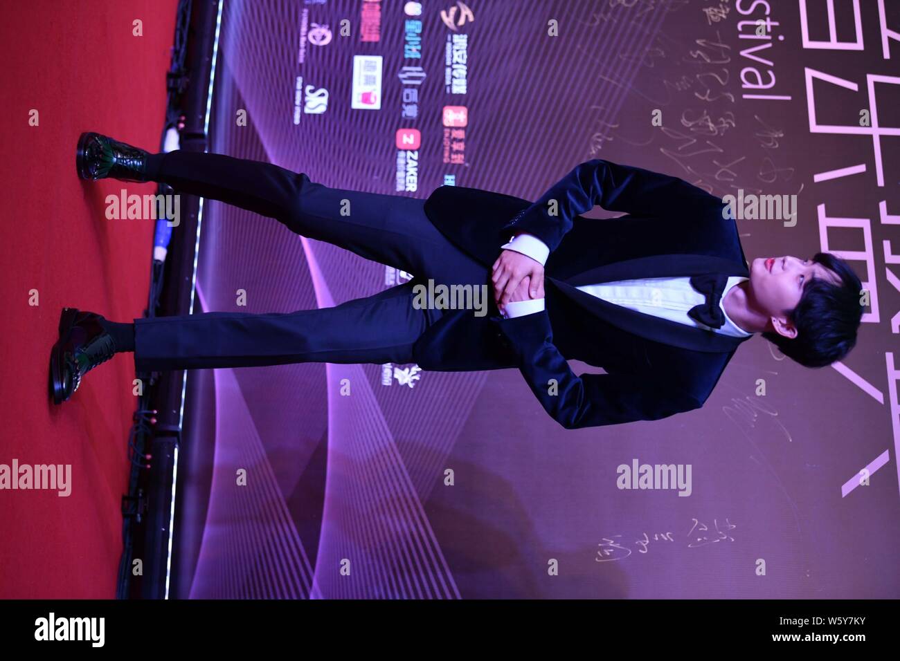 Chinese singer Jin Longguo of South Korean project boy band JBJ poses as he arrives on the red ...