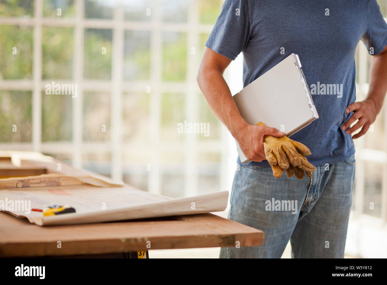 Mid adult man standing on a construction site Stock Photo - Alamy