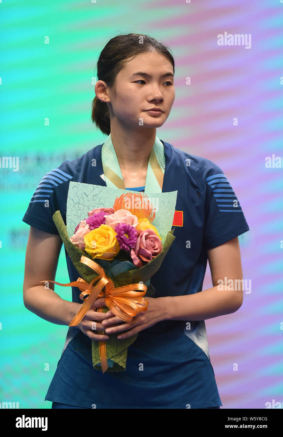 Han Yue of China attends the award ceremony after the final match of ...