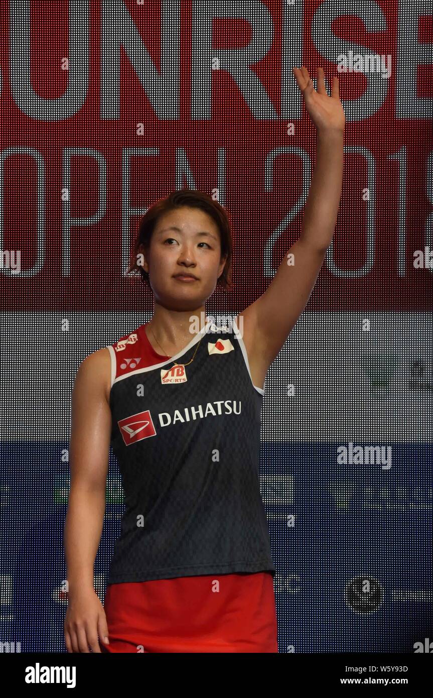 Nozomi Okuhara of Japan poses on the podium after defeating Ratchanok ...