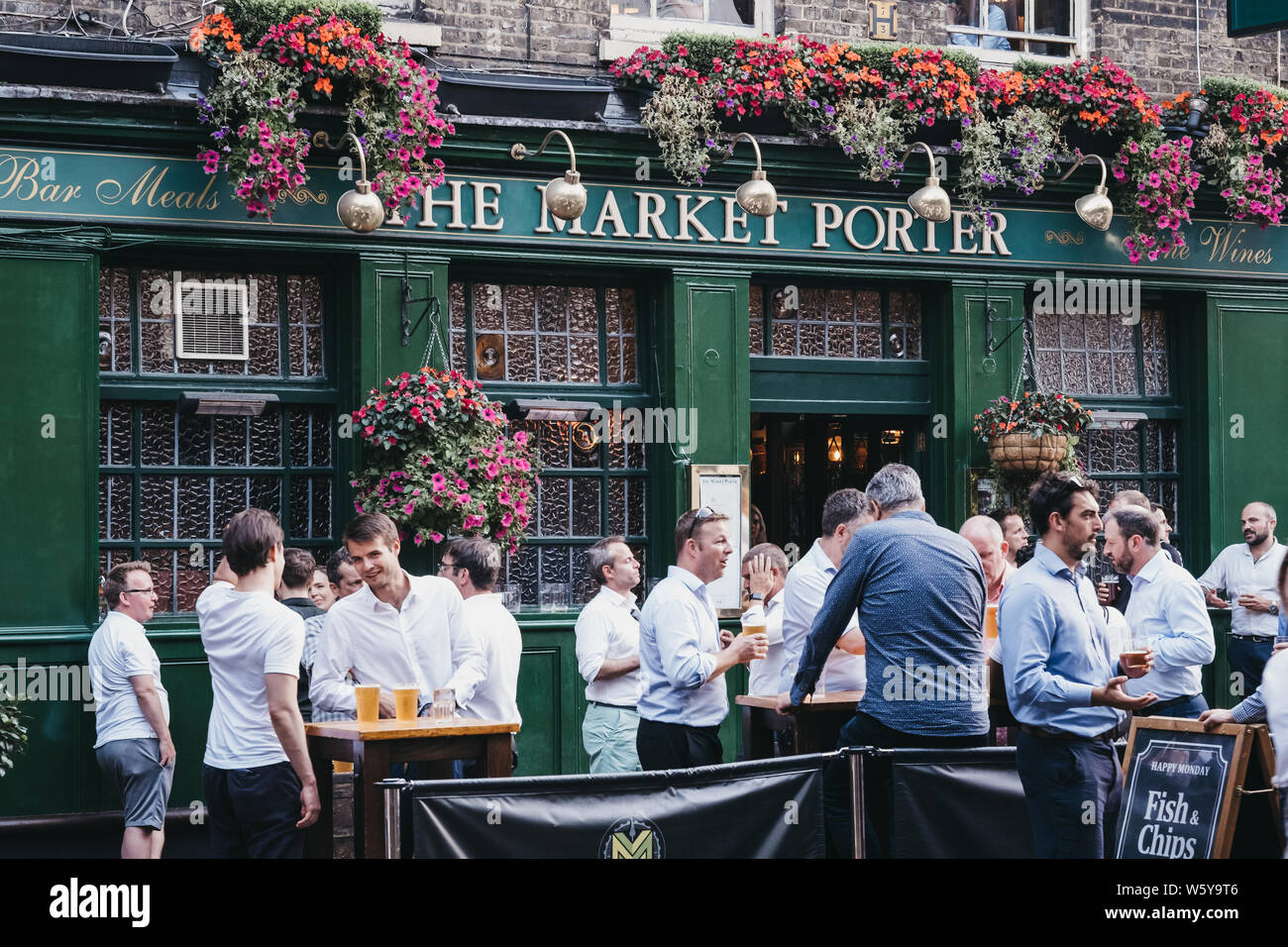 London, UK - July 23, 2019: People standing and drinking outside The ...