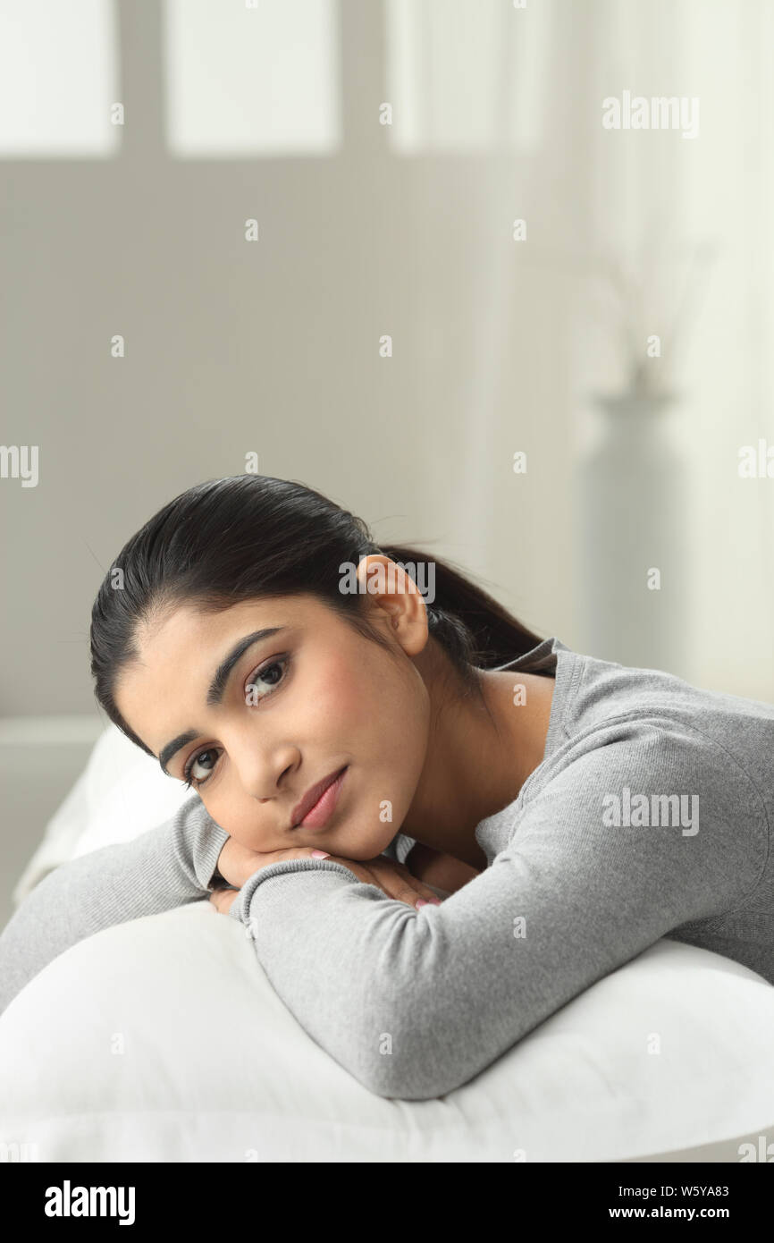 Portrait of a woman lying on bed Stock Photo - Alamy