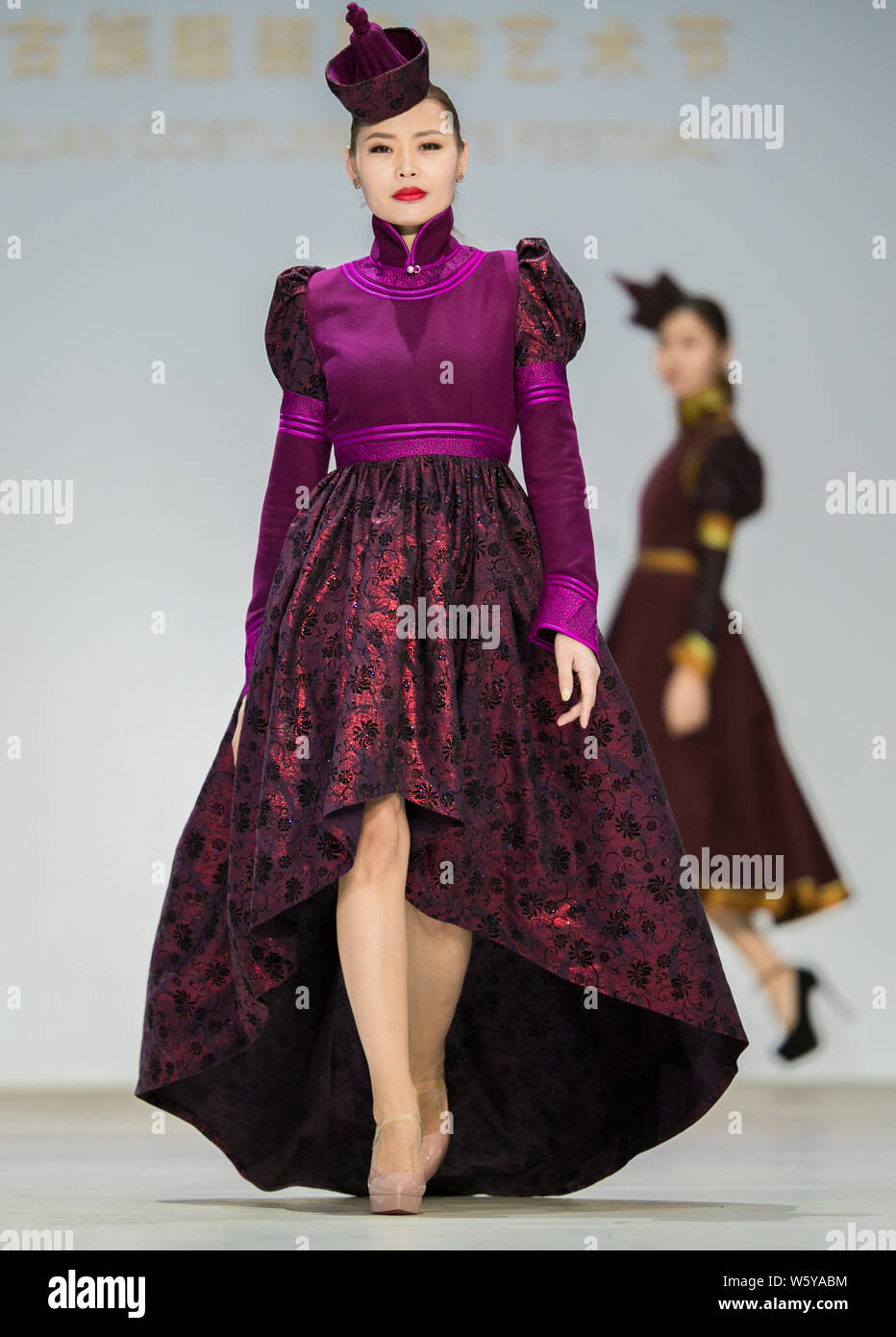 A model displays a new creation of traditional Mongolian costumes ...