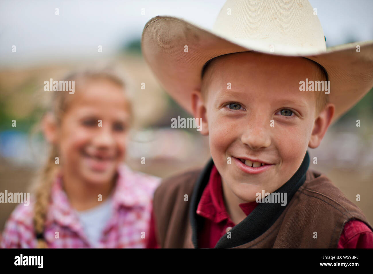 Portrait of two smiling siblings at a ranch Stock Photo - Alamy