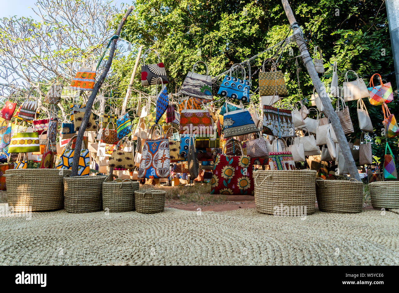 Traditional African market selling colorful bags hanged on trees, FEIMA ...