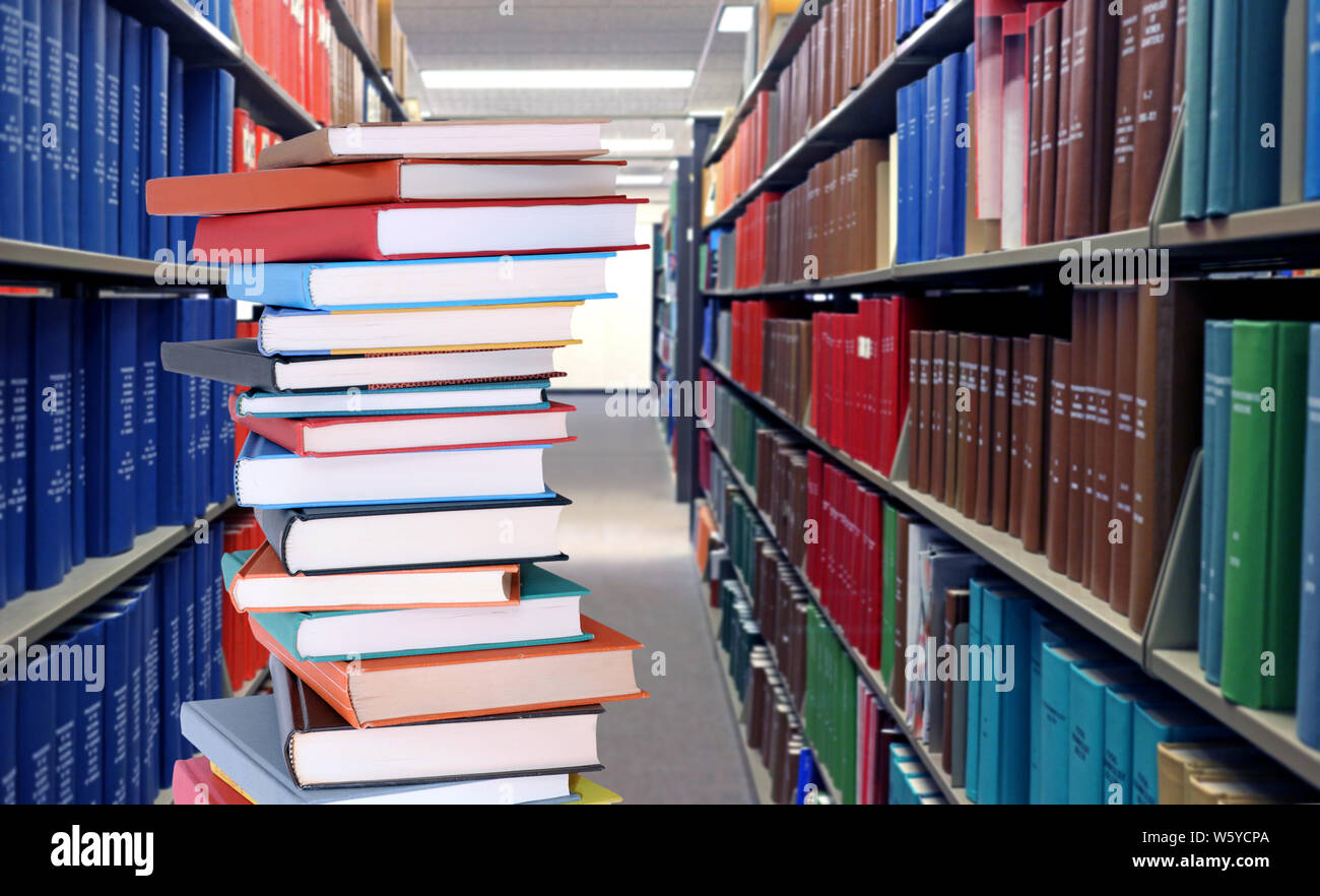 Education concept with stack of book in the library Stock Photo - Alamy