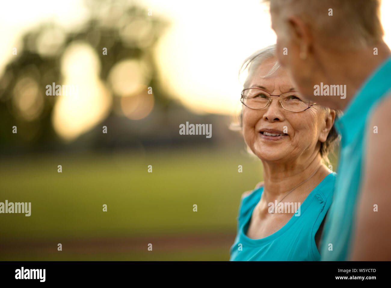 Smiling senior women taking a walk on an athletic track Stock Photo - Alamy