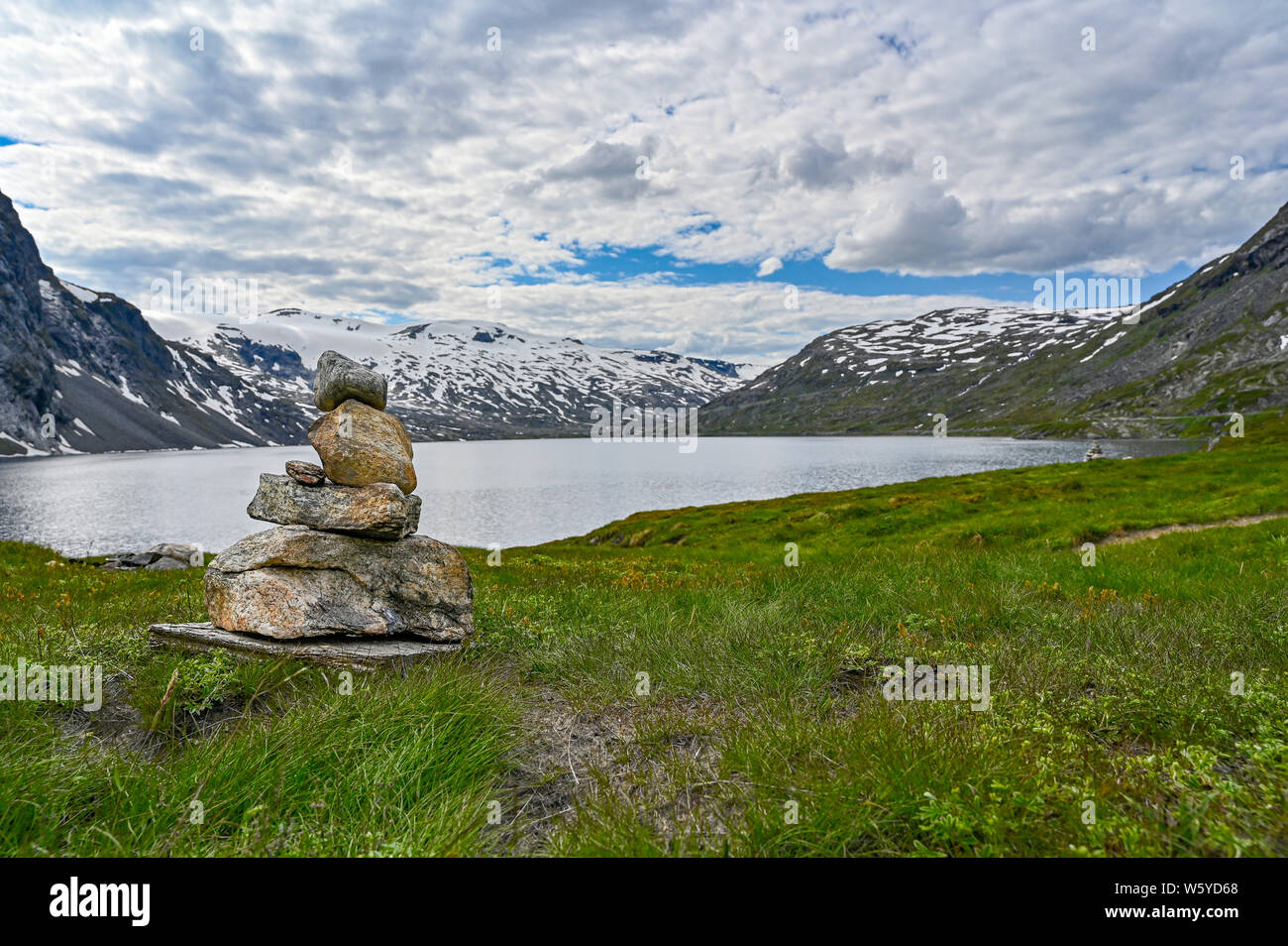 mound of stones near a lake in the mountains of Norway Stock Photo - Alamy