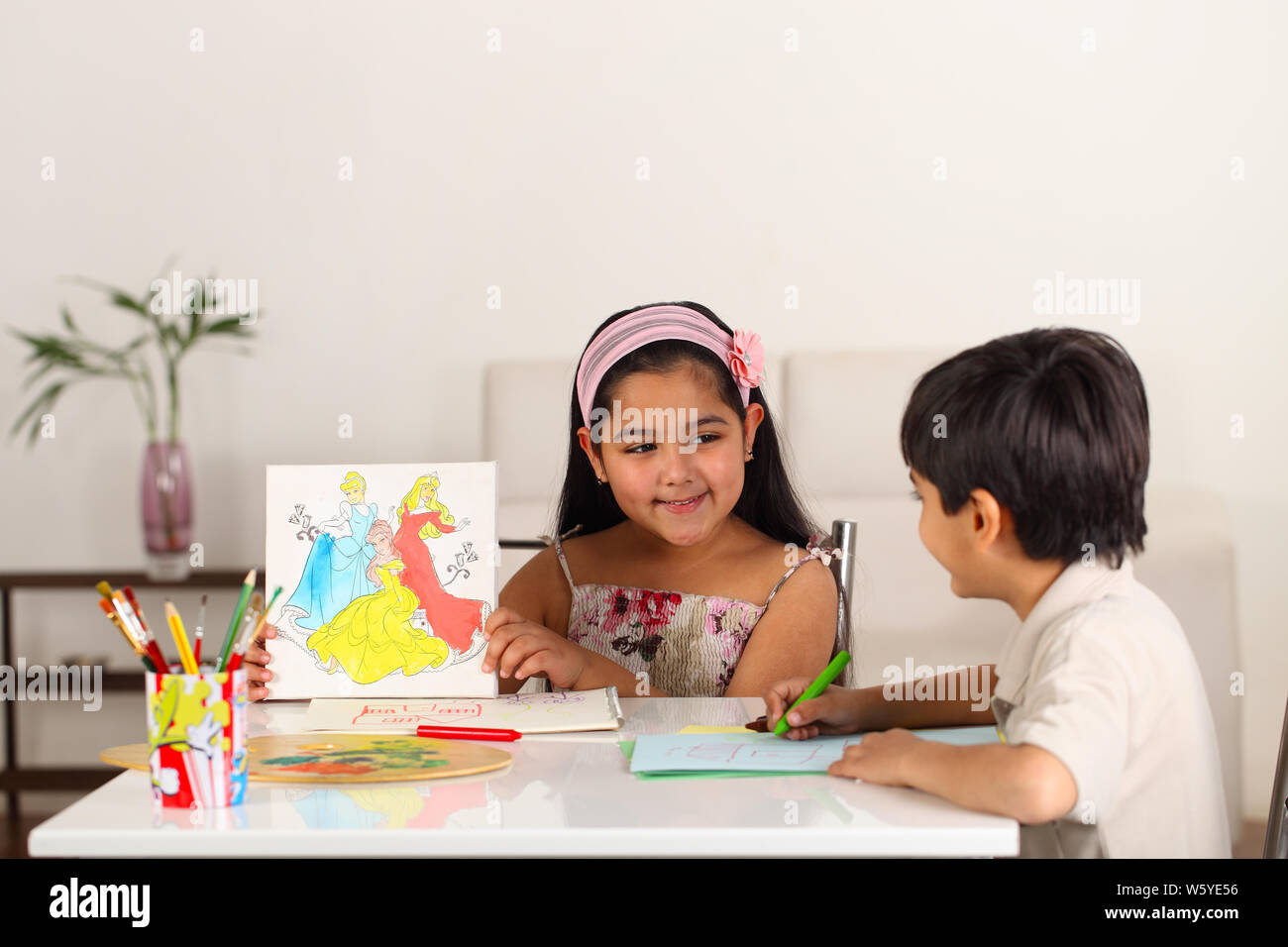 Two children drawing at home Stock Photo - Alamy