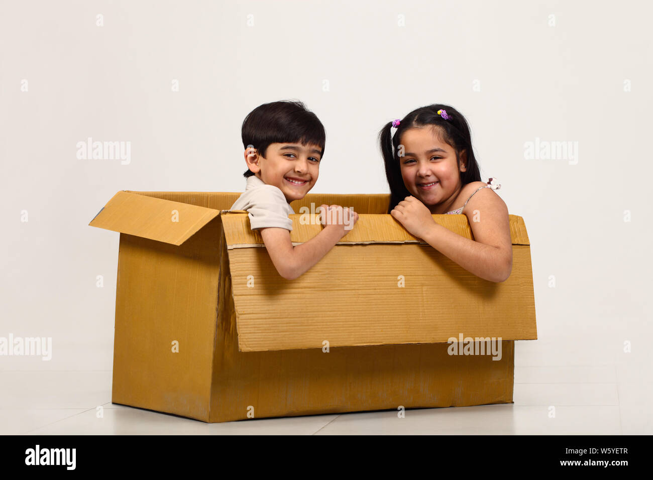 Children playing in cardboard box Stock Photo - Alamy