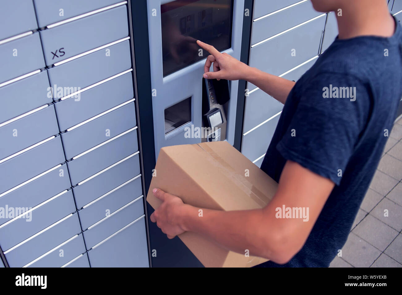 Man client using automated self service post terminal machine or locker ...