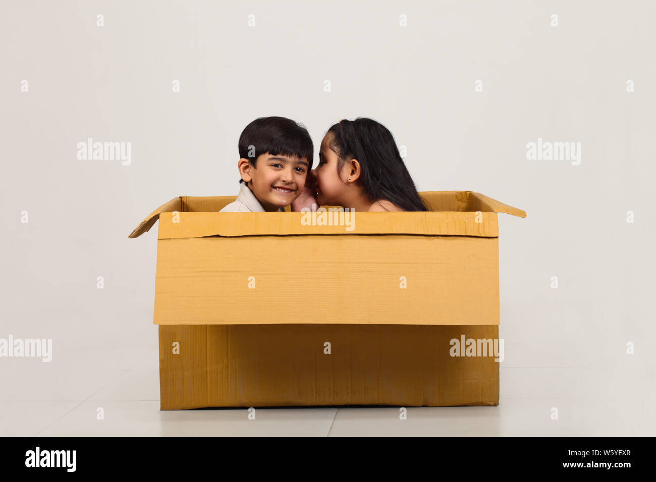 Girl whispering to her brother,s ear Stock Photo - Alamy